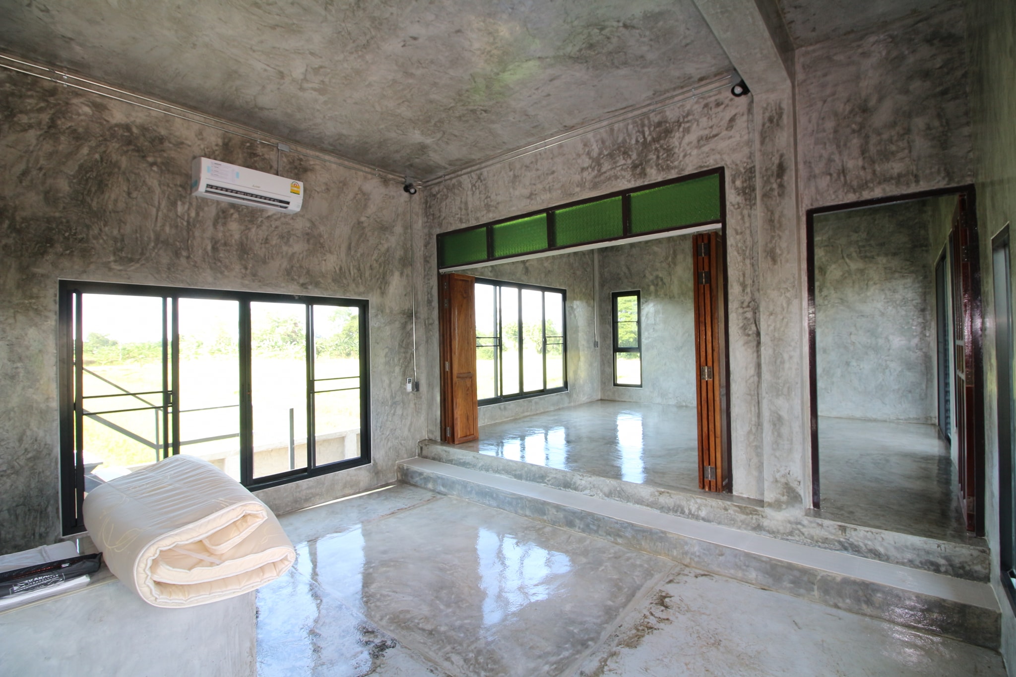 Concrete house on stilts with rural vibe