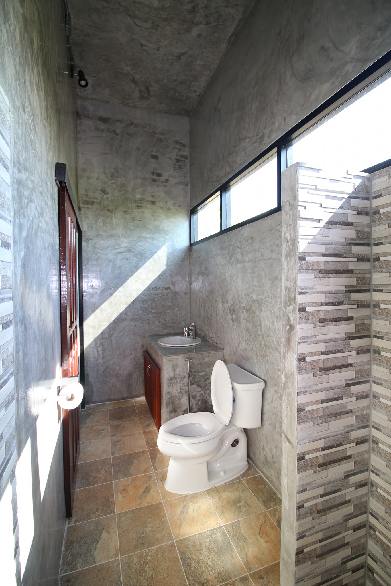 Concrete house on stilts with rural vibe